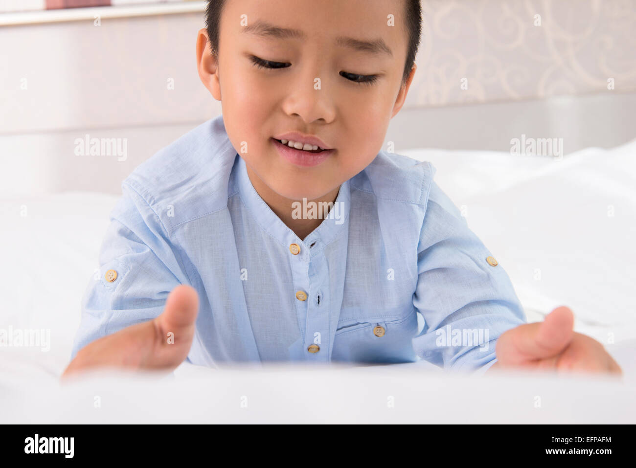 Boy using tablet in bed Stock Photo - Alamy