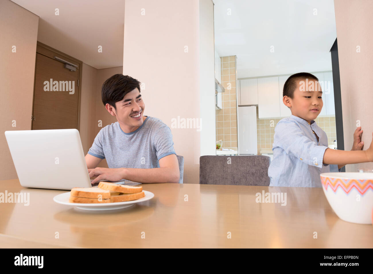 Father working at home with son Stock Photo - Alamy