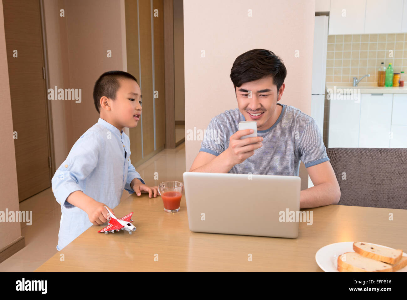 Busy father working laptop hi-res stock photography and images - Alamy