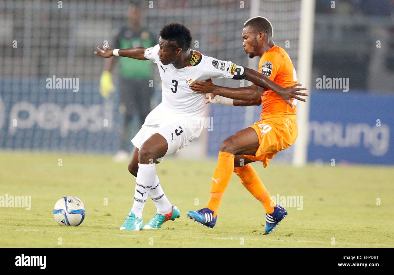 Asamoah Gyan of Ghana shields against Serey Die of Ivory Coast during ...