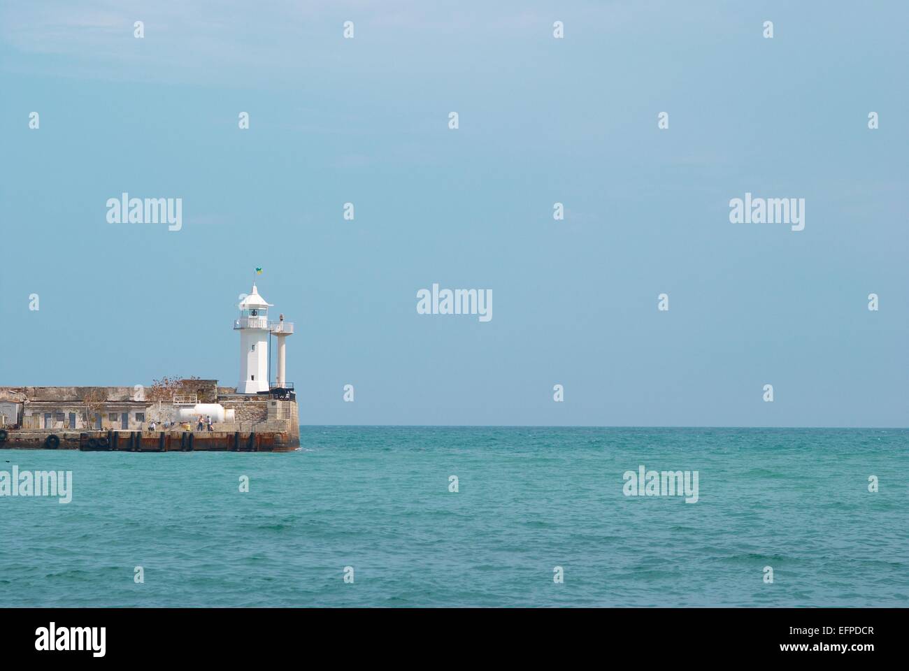 Lighthouse in the bay with sea and sky Stock Photo - Alamy