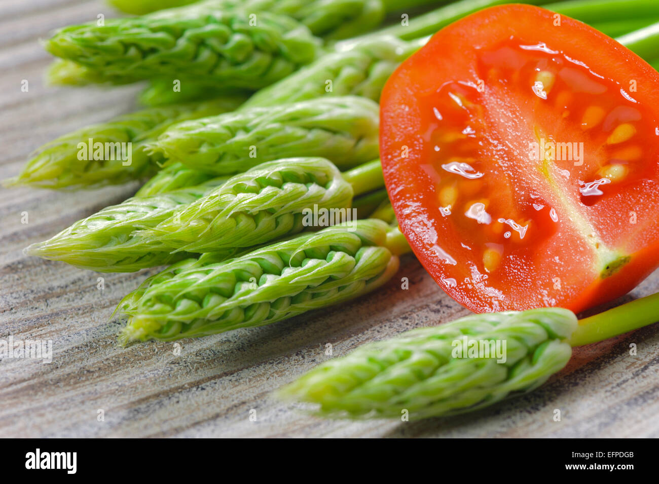 wild green asparagus with red sliced tomato Stock Photo - Alamy