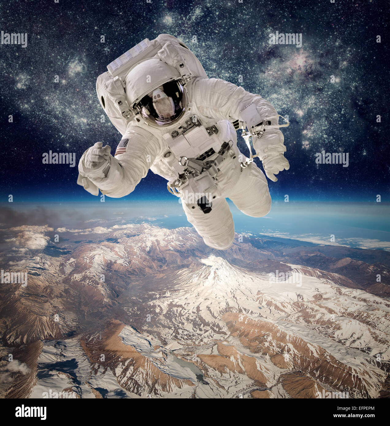Astronaut in outer space against the backdrop of the planet earth ...