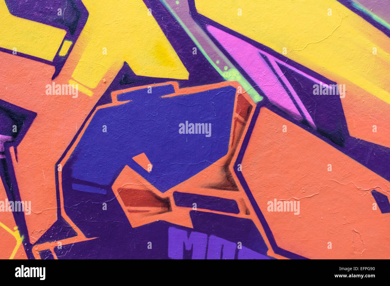 Bright blue and orange graffiti on a cracked wall Stock Photo - Alamy