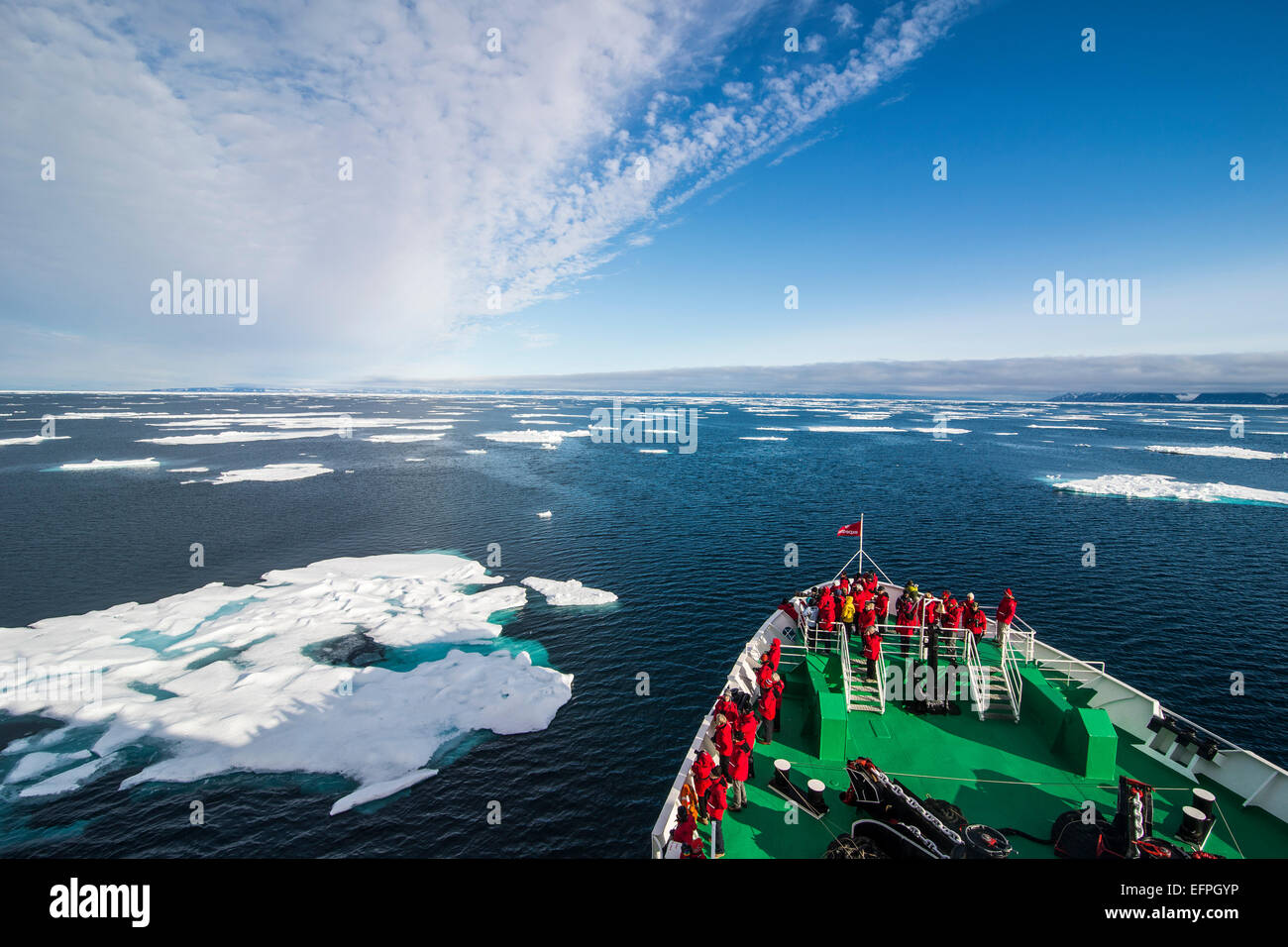 Expedition boat entering the pack ice in the Arctic shelf, Svalbard ...