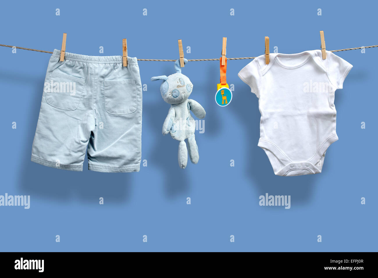 Baby boy clothes on the clothesline Stock Photo - Alamy