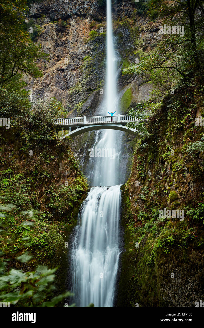 Male hiker crossing footbridge over Multnomah Falls, Oregon, USA Stock ...