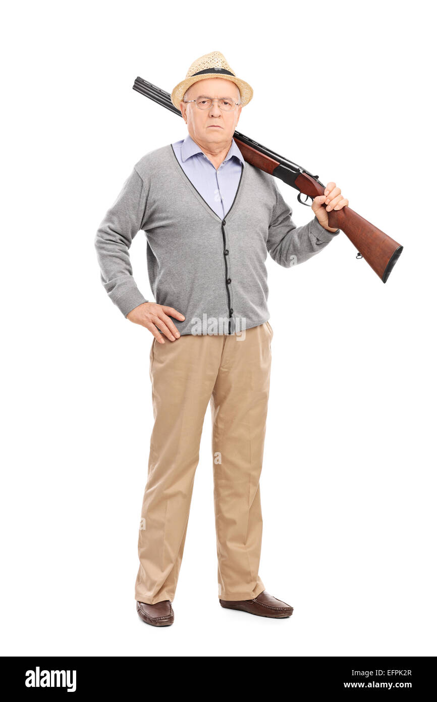 Full length portrait of a senior gentleman posing with a rifle isolated ...