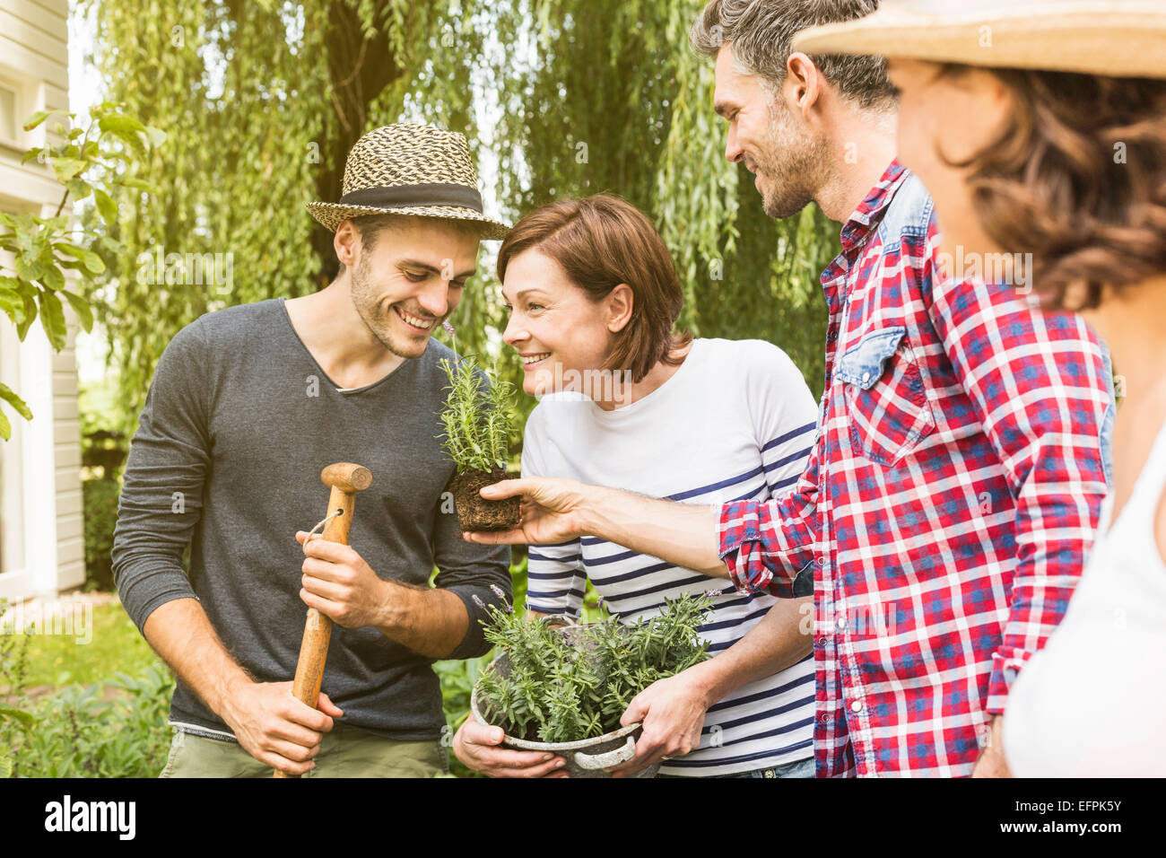 Group of friends gardening Stock Photo - Alamy