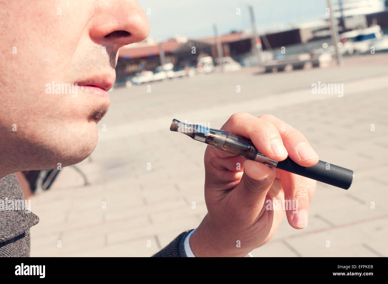 a young man vaping with an electronic cigarette Stock Photo - Alamy