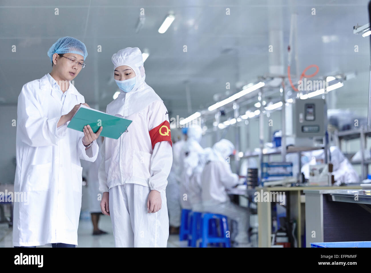 Workers having discussion in ecigarette factory Stock Photo - Alamy