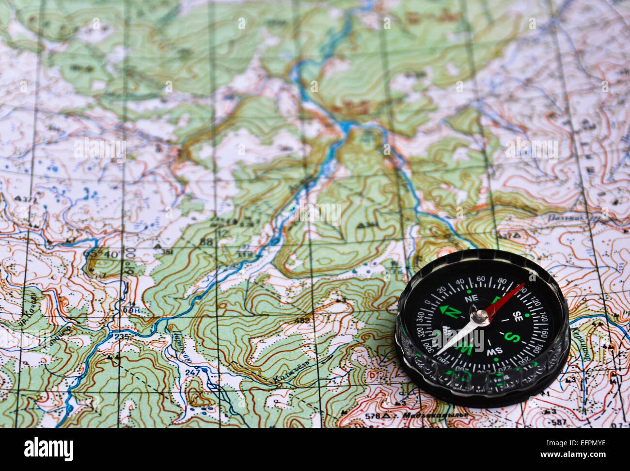 The magnetic compass is located on a topographic map. Satellites ...