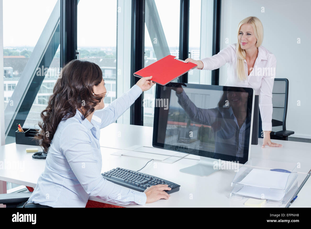 Female office worker giving hi-res stock photography and images - Alamy