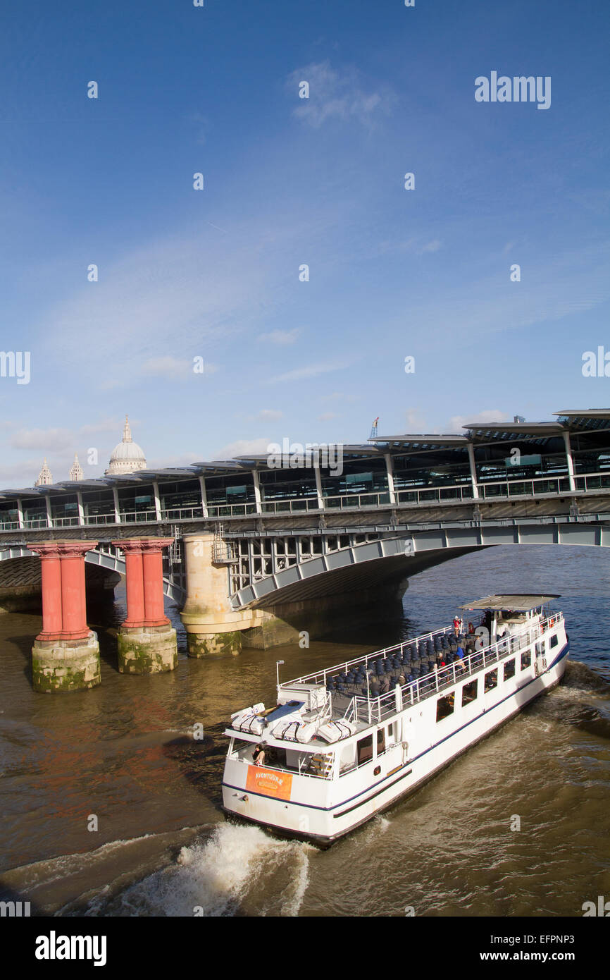 River bus passes under the new Blackfriars railway Bridge in London ...