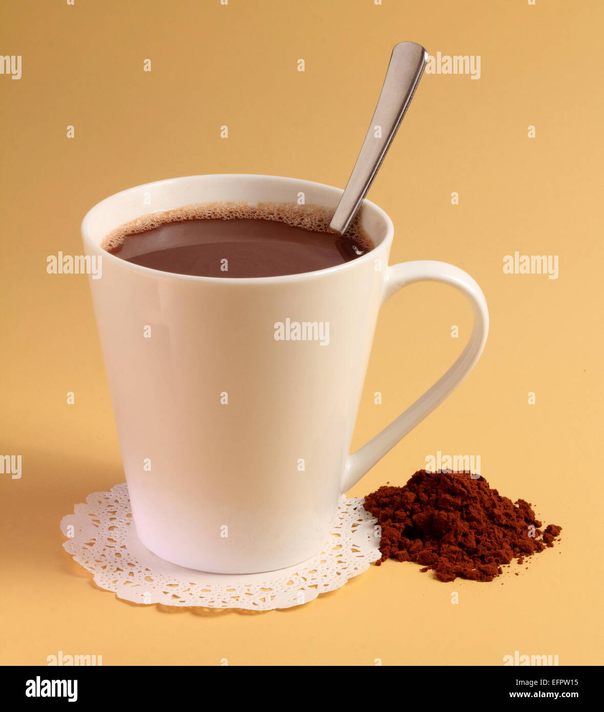 Hot chocolate drink and chocolate powder on simple yellow background ...