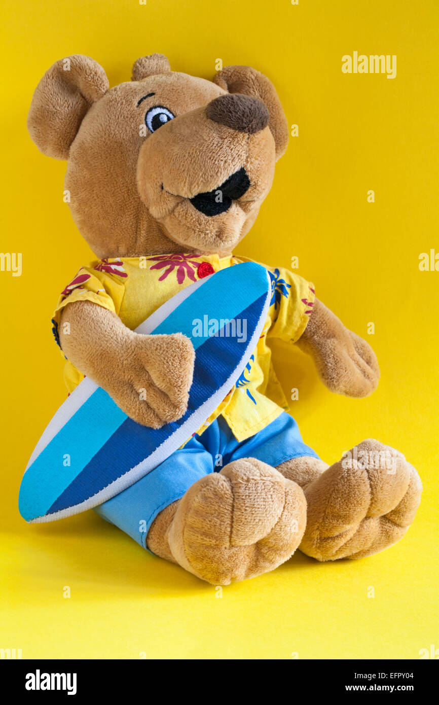Surfing Sandy surf bear soft cuddly toy isolated on yellow background ...