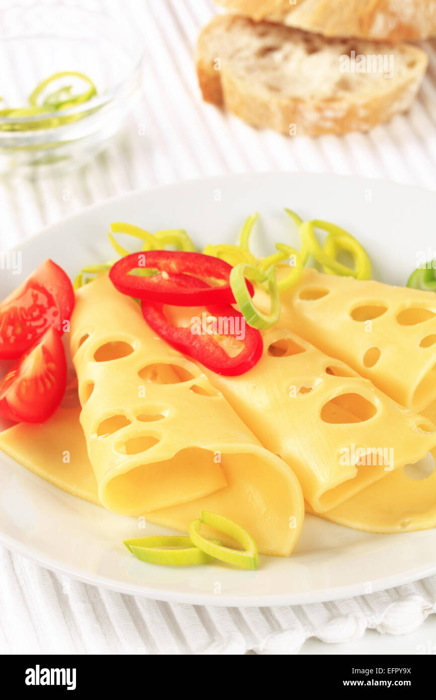 Slices of Swiss cheese sprinkled with chopped leek Stock Photo - Alamy