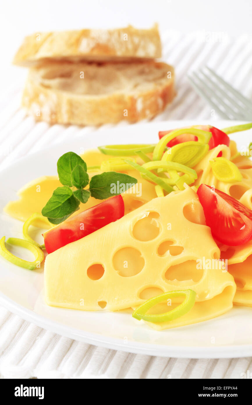 Slices of Swiss cheese sprinkled with chopped leek Stock Photo - Alamy