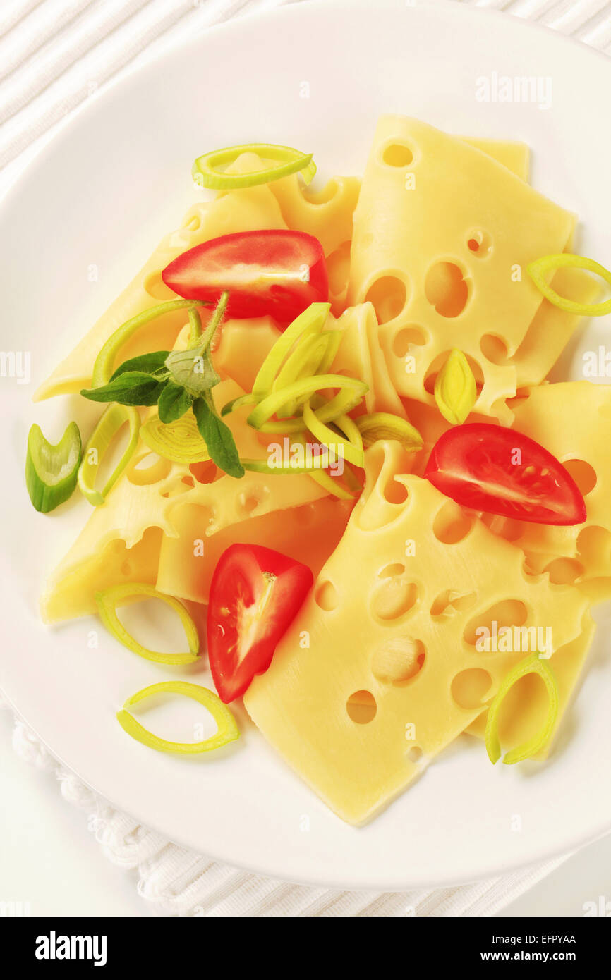 Slices of Swiss cheese sprinkled with chopped leek Stock Photo - Alamy