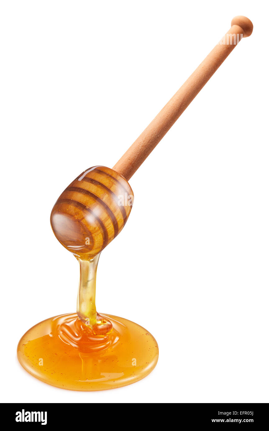 Honey flowing from wooden stick on white background. Clipping paths ...