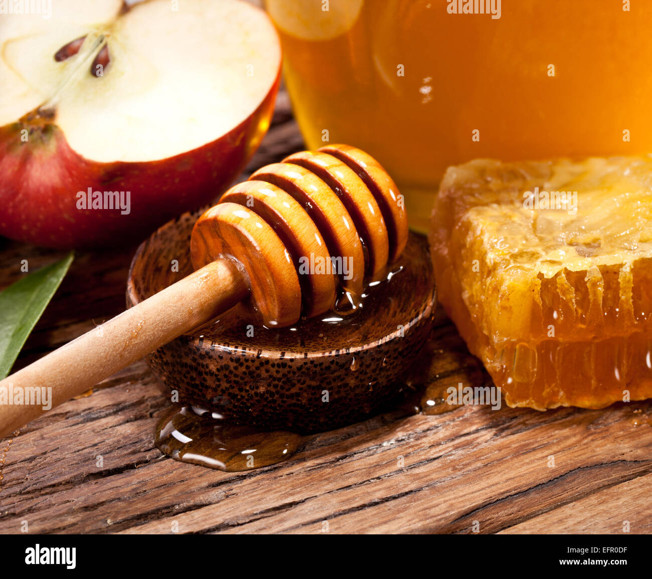 Honeycombs and wooden dipper. Can and apple on the background Stock ...