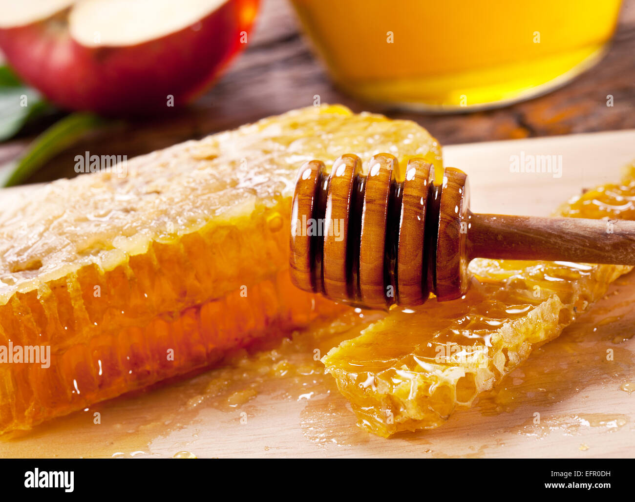 Honeycombs and wooden dipper. Can and apple on the background Stock ...