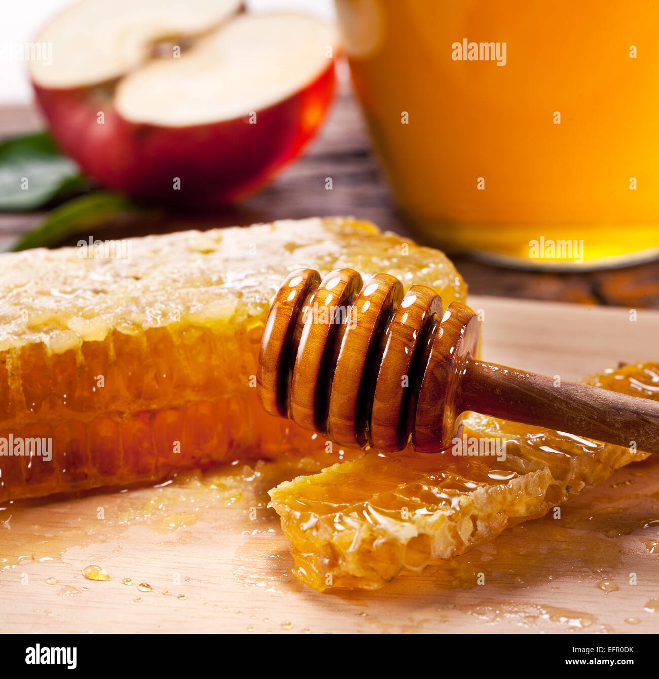 Honeycombs and wooden dipper. Can and apple on the background Stock ...