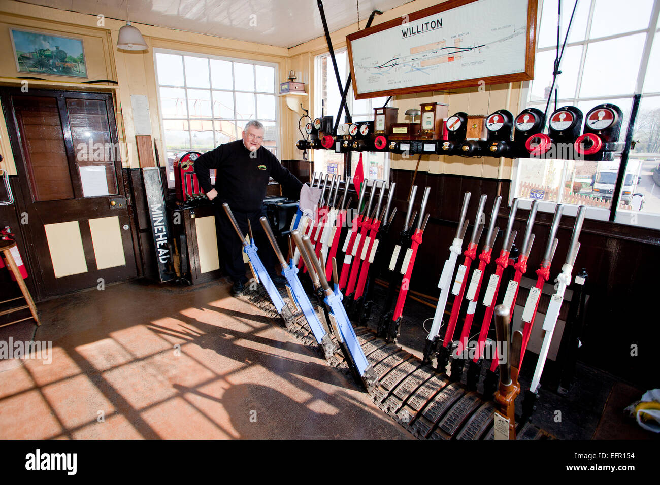 The signalman at Williton station on the West Somerset Railway at work ...