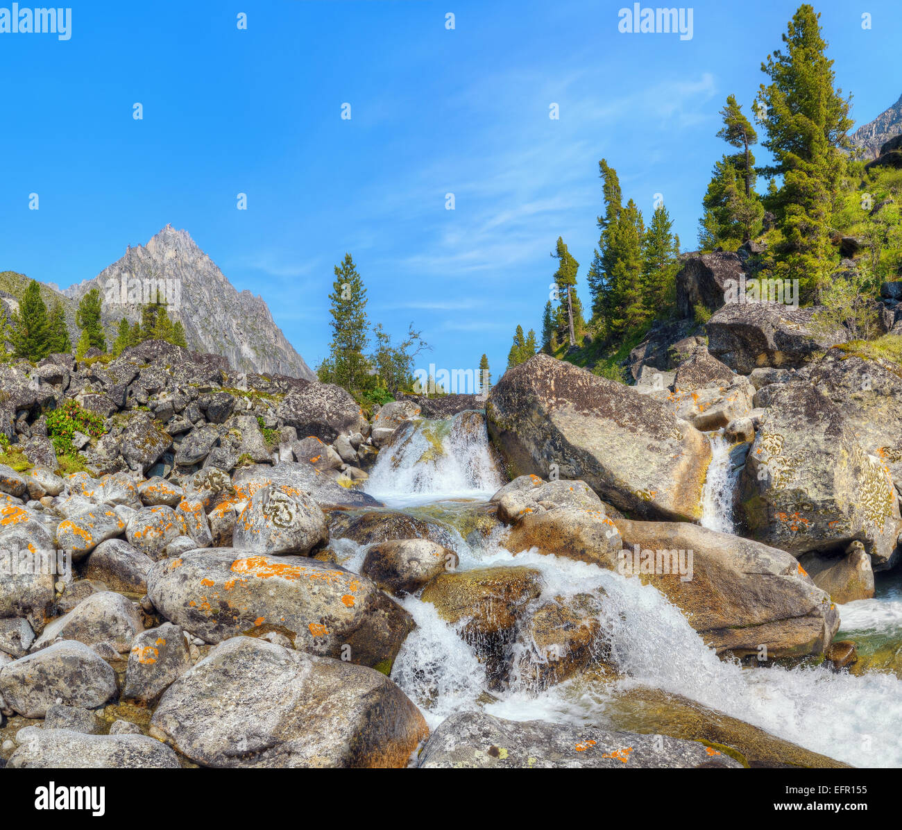 Small cascade of waterfalls on a mountain creek. Eastern Sayan ...