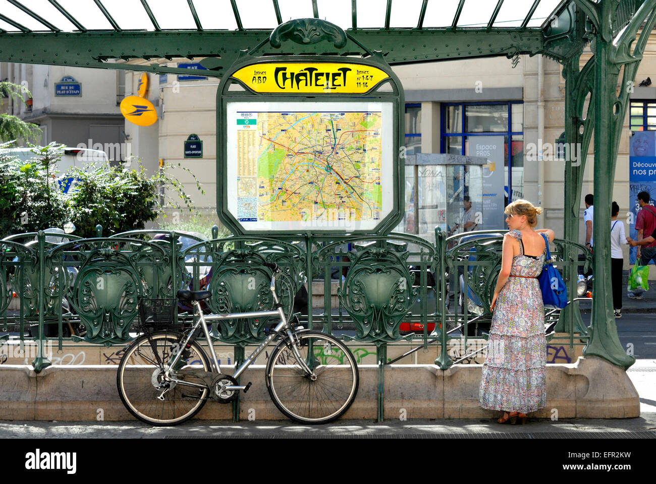 Paris, France. Metro sign, map, bicycle and young woman - Chatelet ...