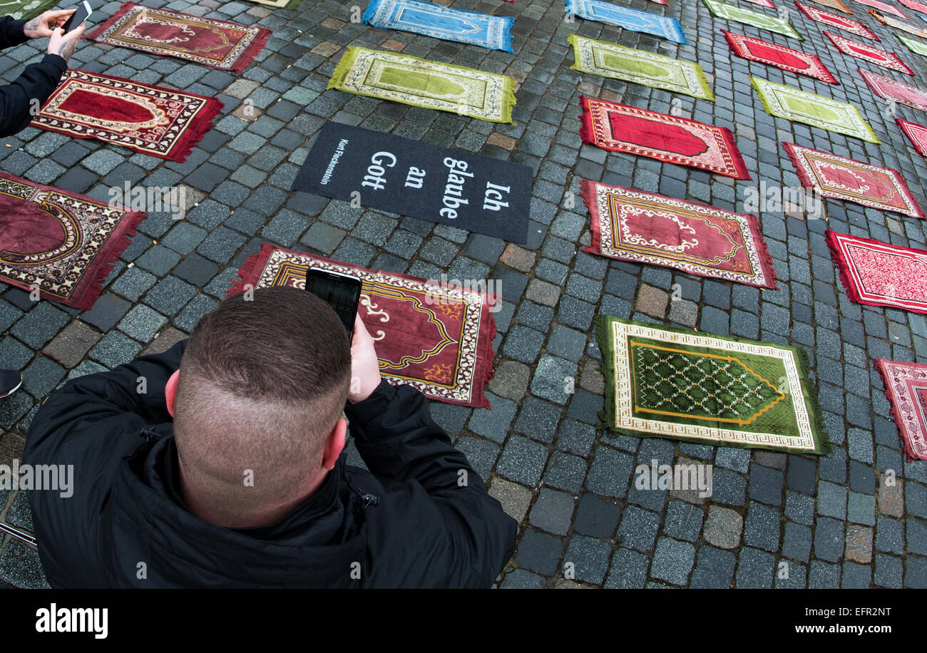 A man takes a picture of 175 Muslim prayer rugs lie in front of Dresden ...