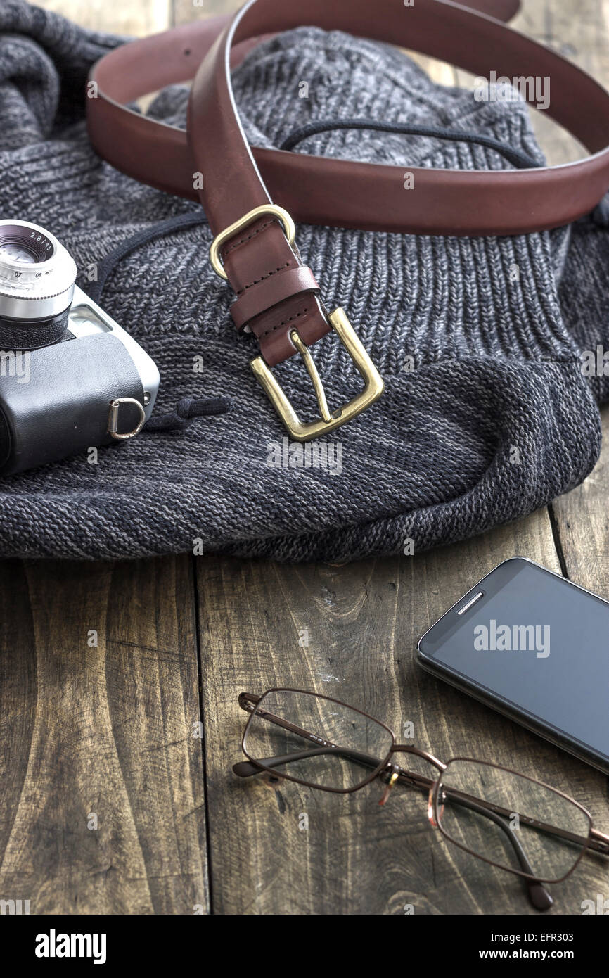 Close up shot of men's winter clothes laid out on a wooden background ...