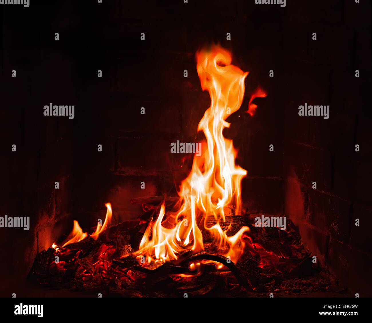 Fireplace burning. Warm burning and glowing fire in fireplace. Close up ...