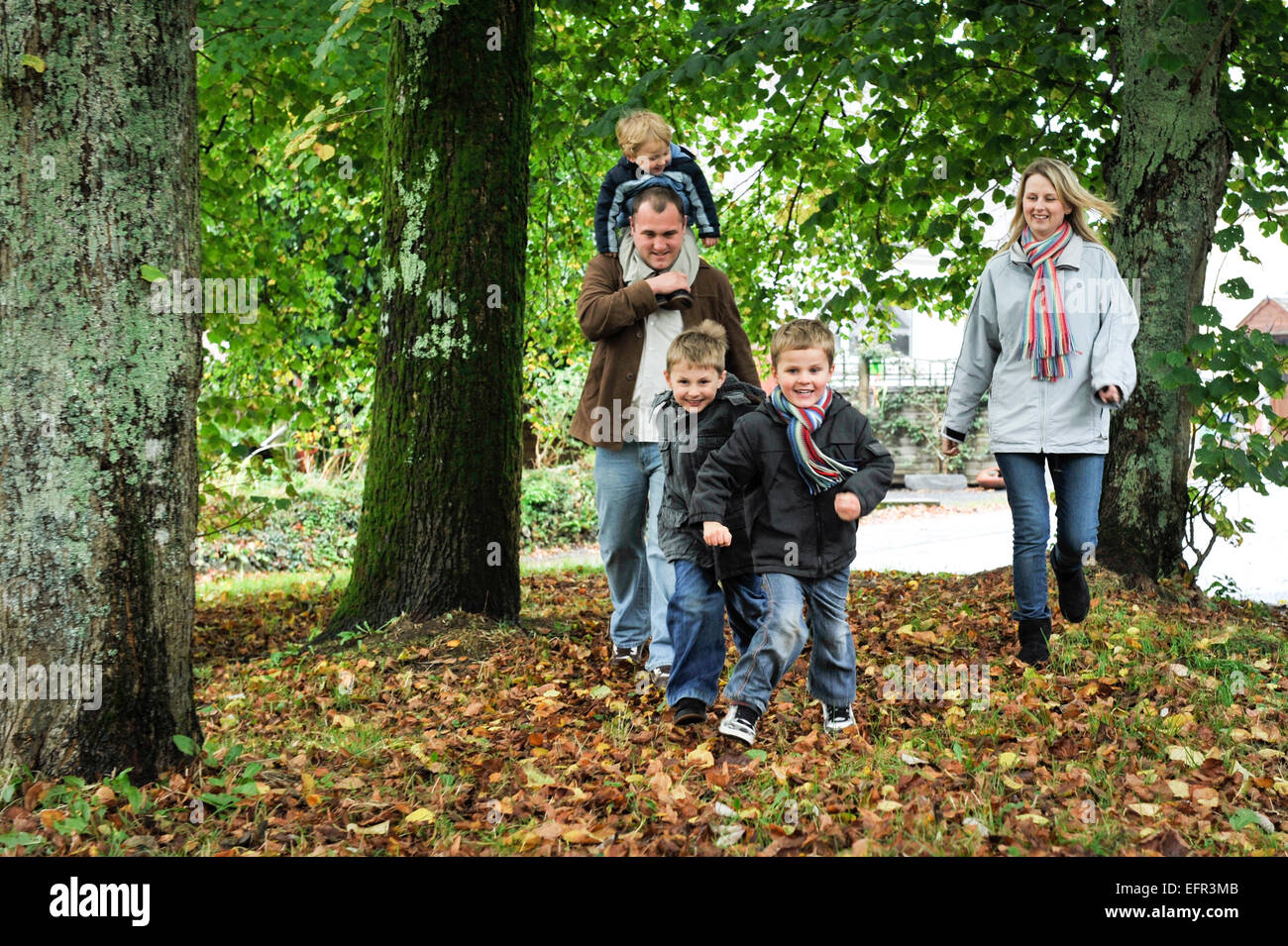 Mum and child running outdoors leaves hi-res stock photography and ...