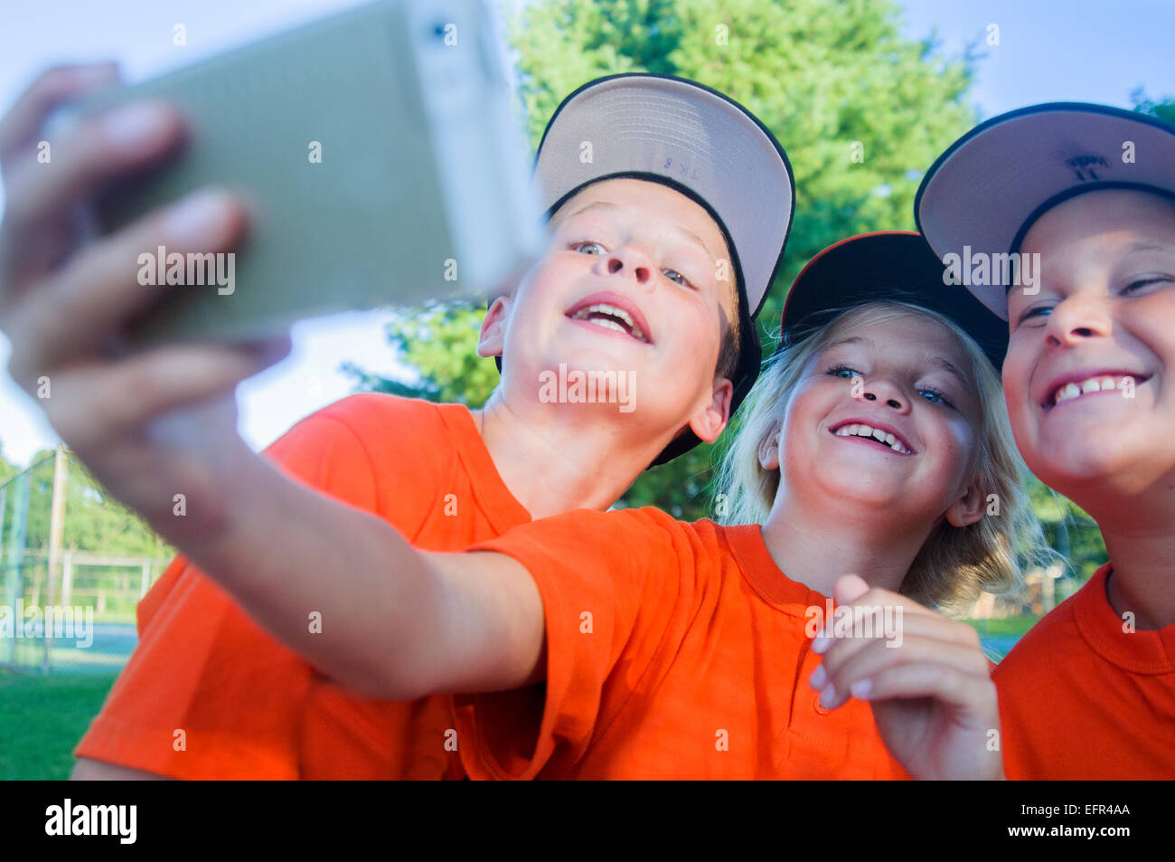 Young baseball players taking self portrait using smartphone Stock ...