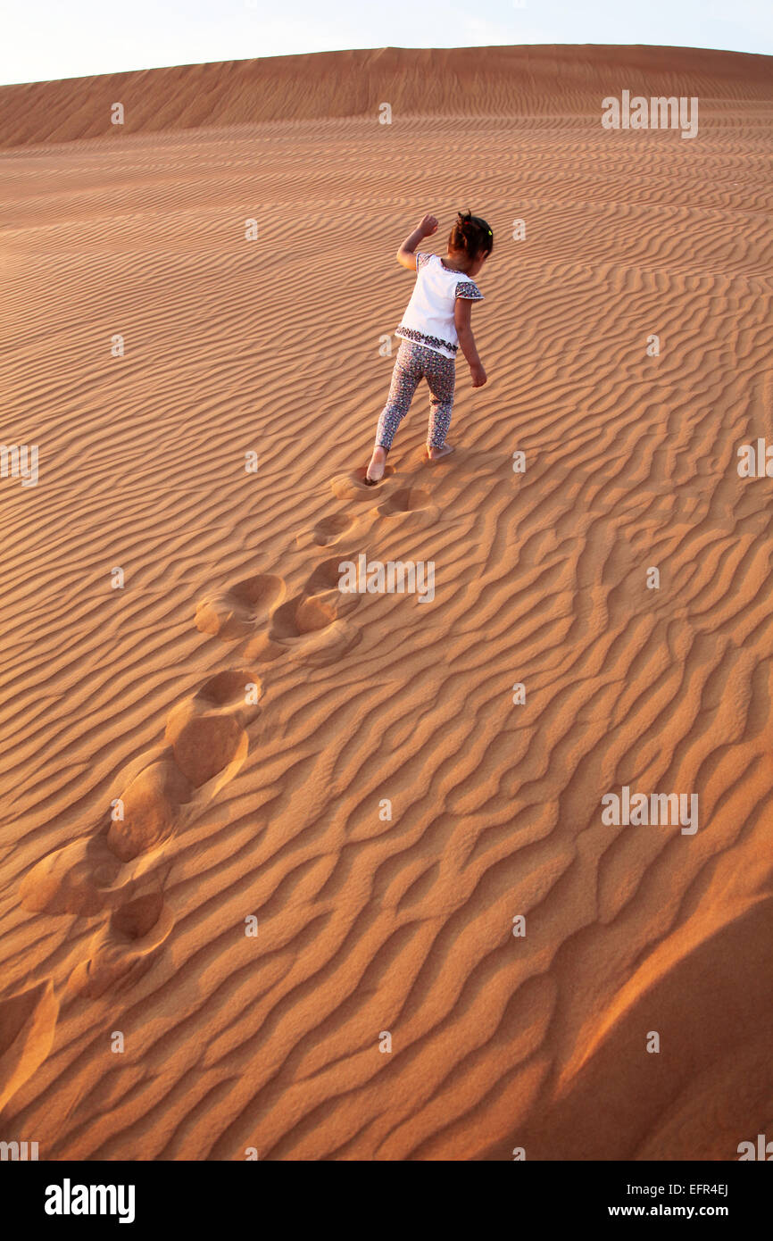 Baby - girl running in the desert Stock Photo - Alamy