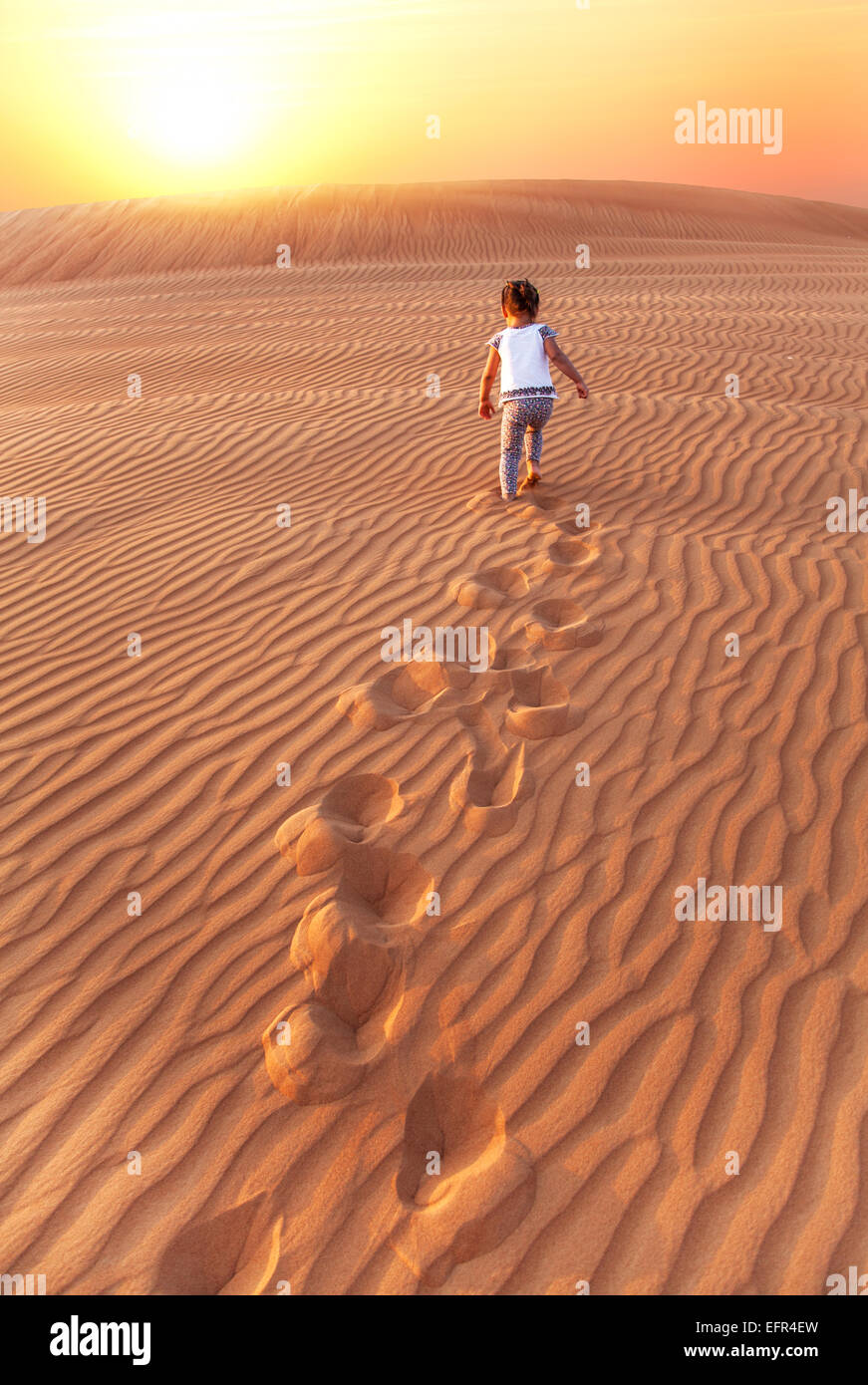 Baby - girl running in the desert Stock Photo - Alamy