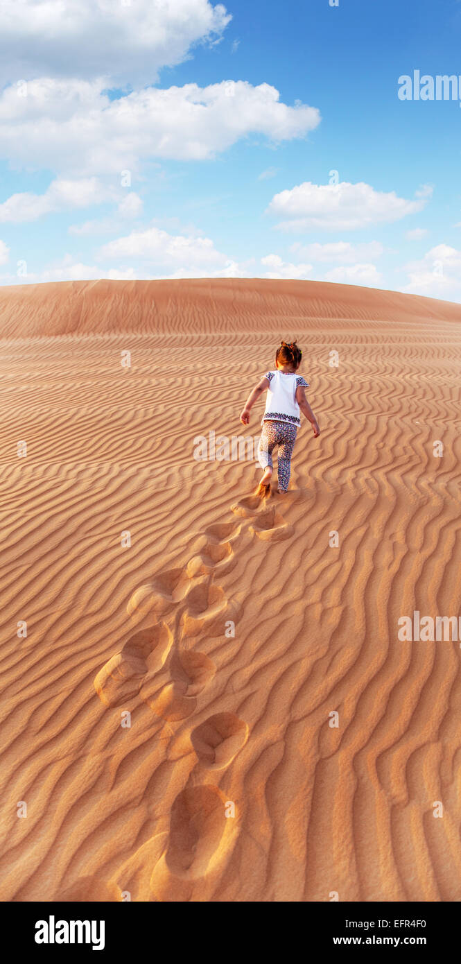 Baby - girl running in the desert Stock Photo - Alamy