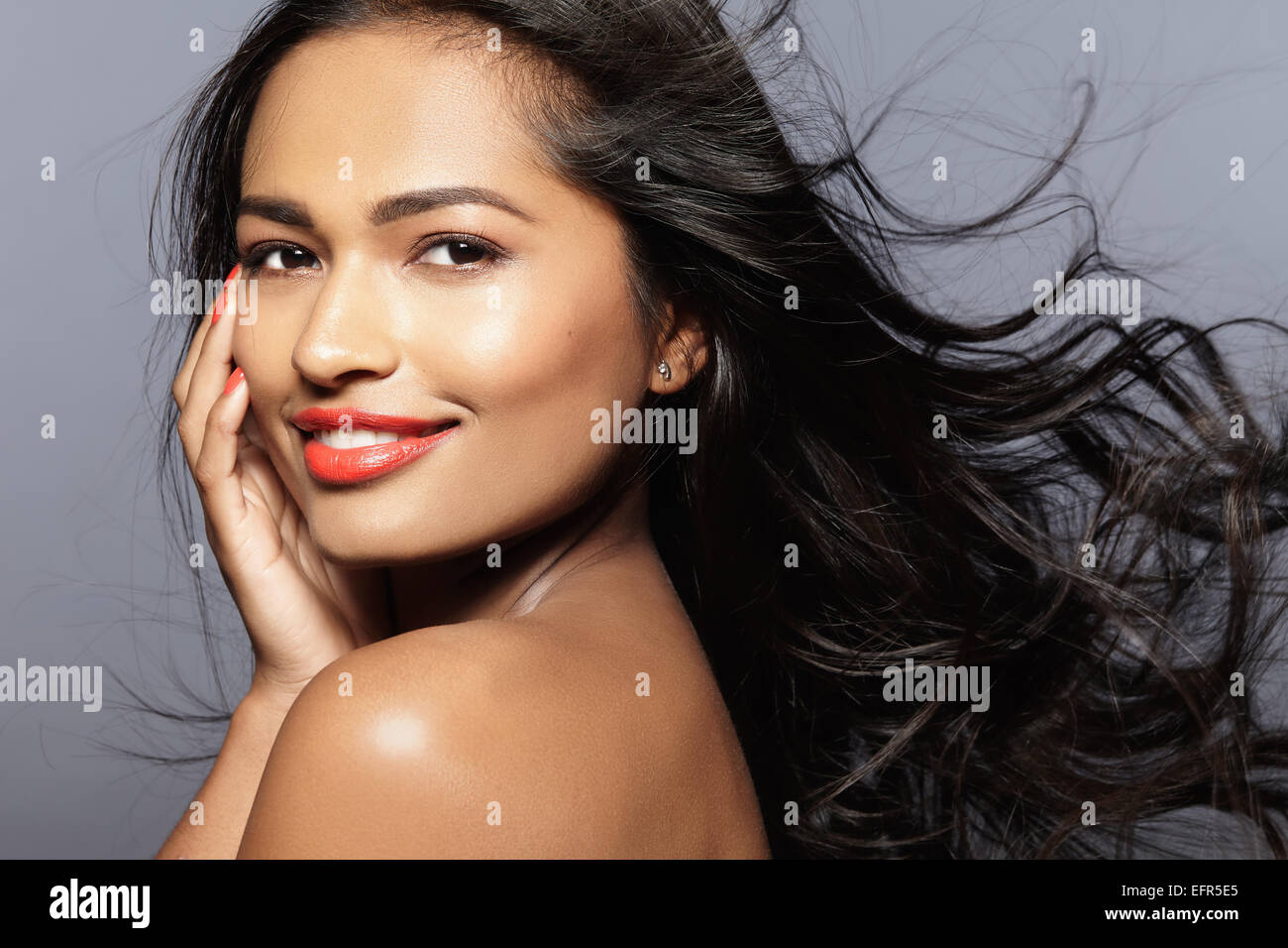Female model smiling, looking over shoulder Stock Photo - Alamy