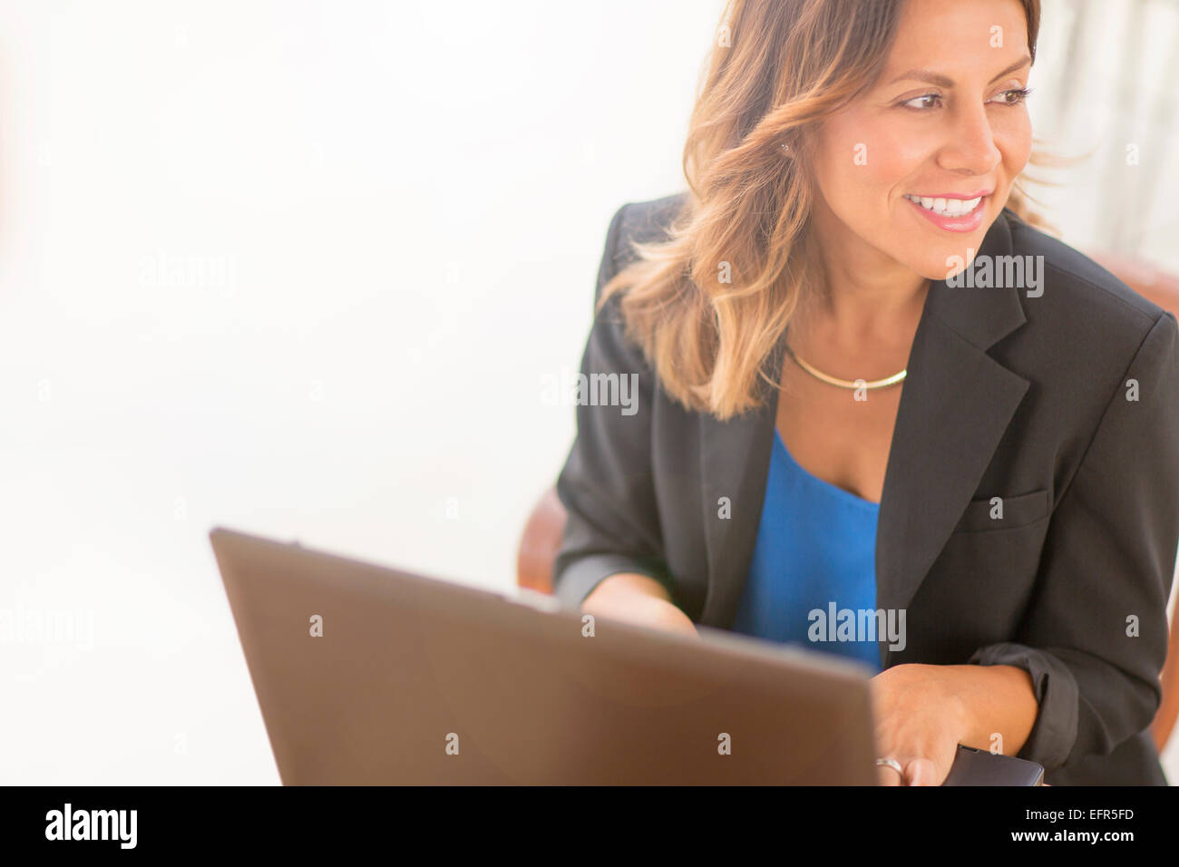 Business woman using laptop Stock Photo - Alamy