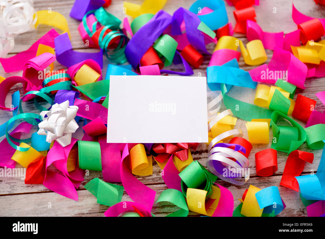 Greeting card in the pile of confetti Stock Photo - Alamy