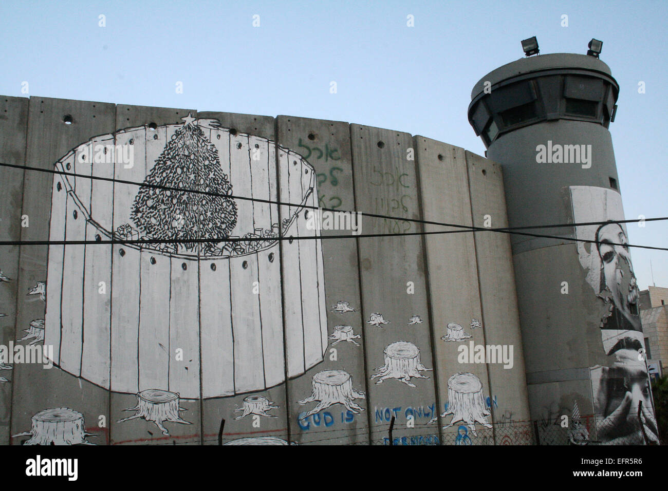 A graffiti Christmas tree surrounded by the Separation Barrier ...