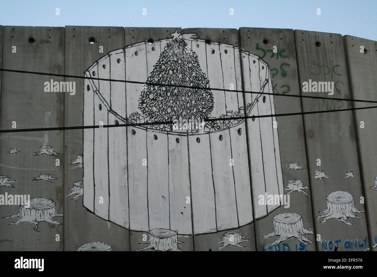 A graffiti Christmas tree surrounded by the Separation Barrier ...