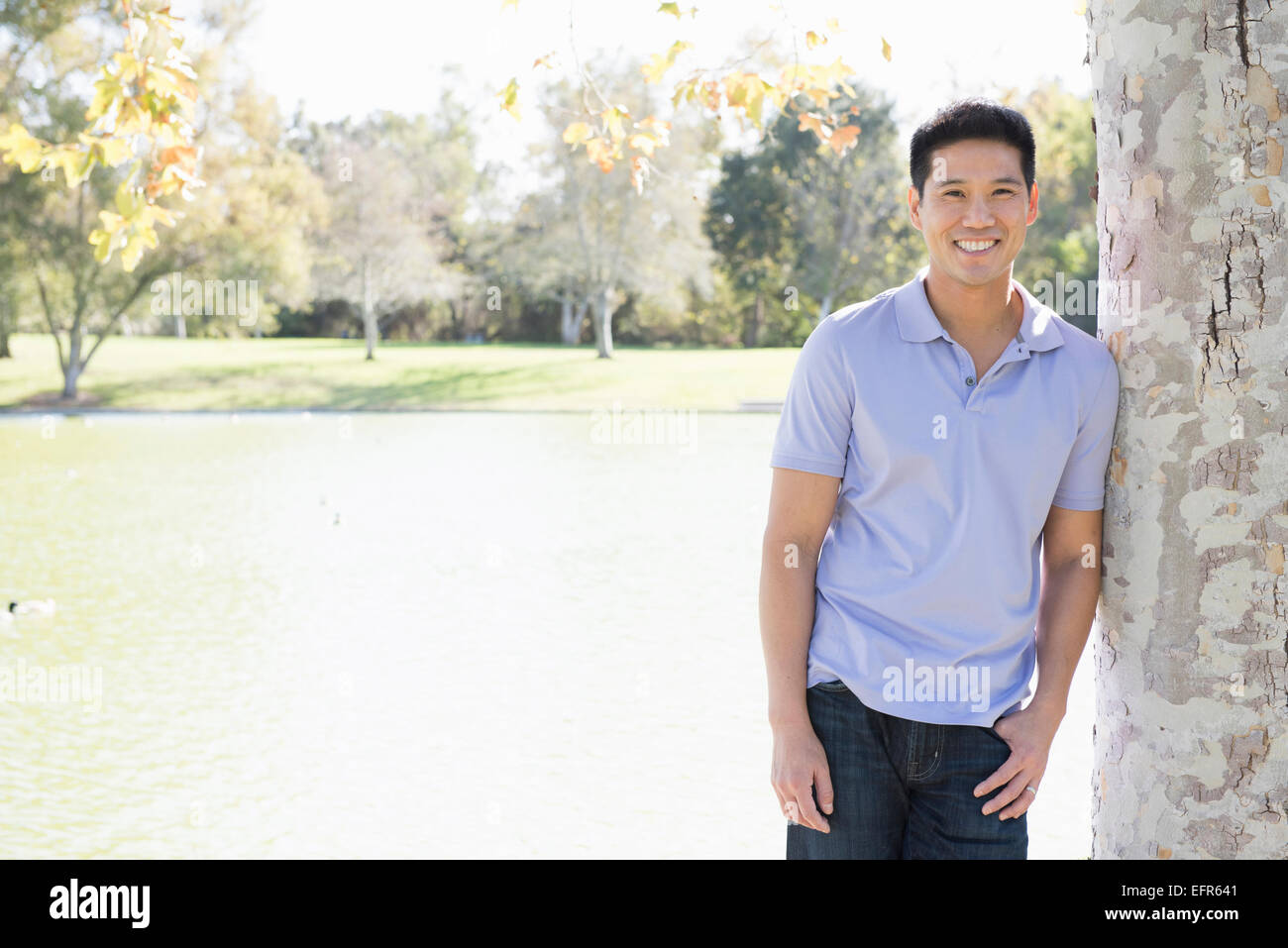 Man leaning against tree hi-res stock photography and images - Alamy