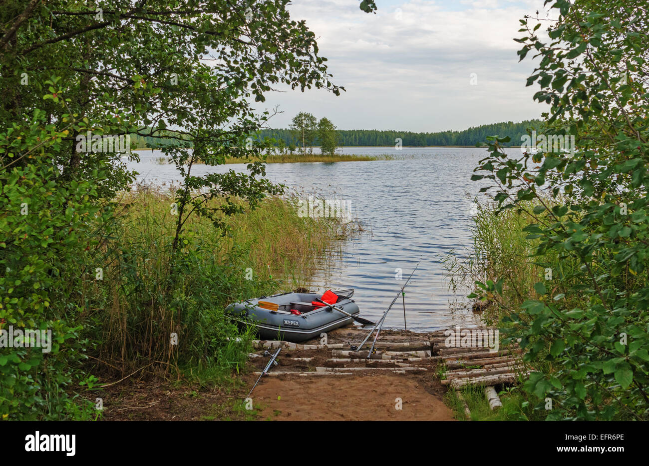 Summer lake, cane, boat and fishing Stock Photo - Alamy