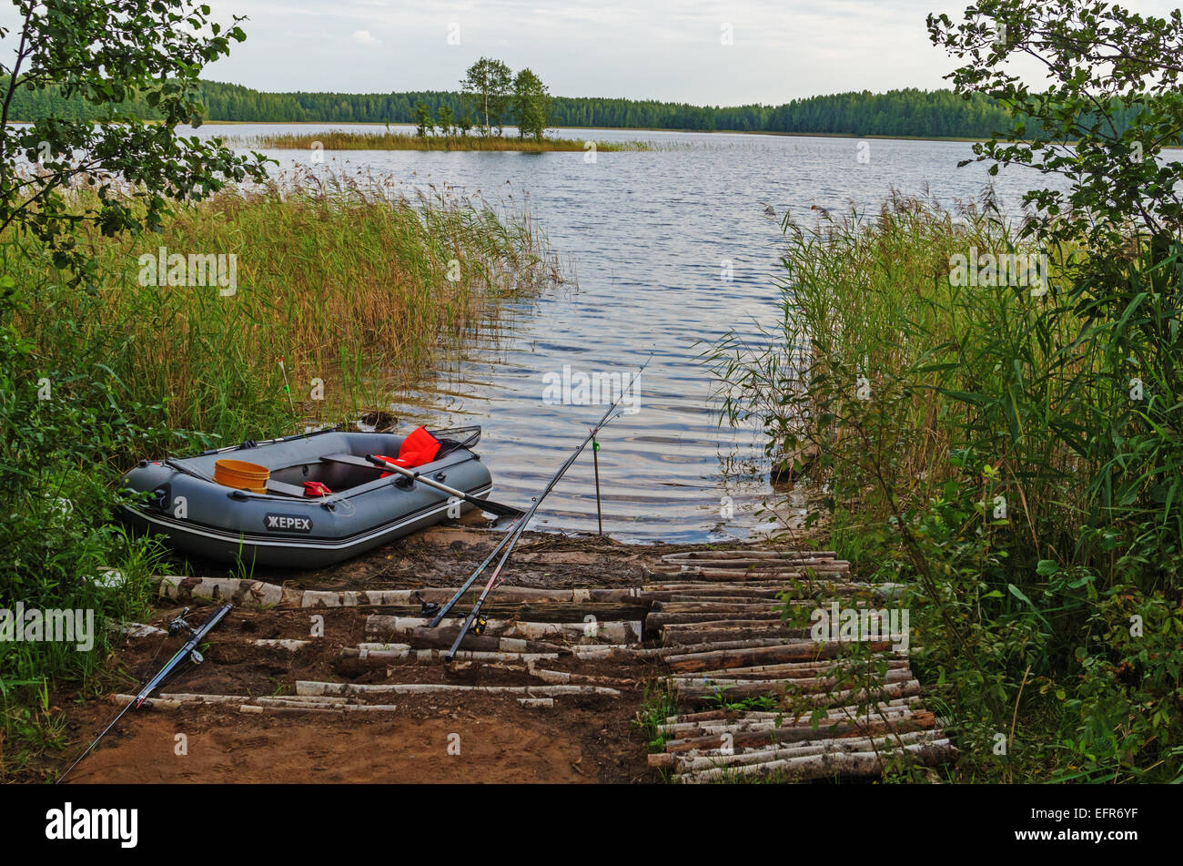Summer lake, cane, boat and fishing Stock Photo - Alamy