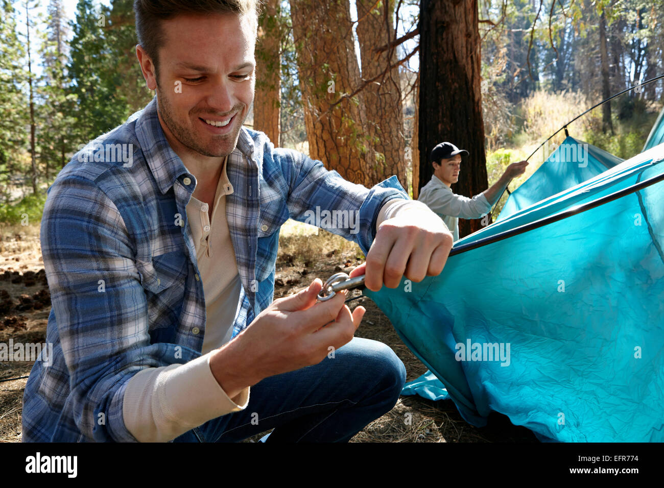 Man in camping gear crouching hi-res stock photography and images - Alamy