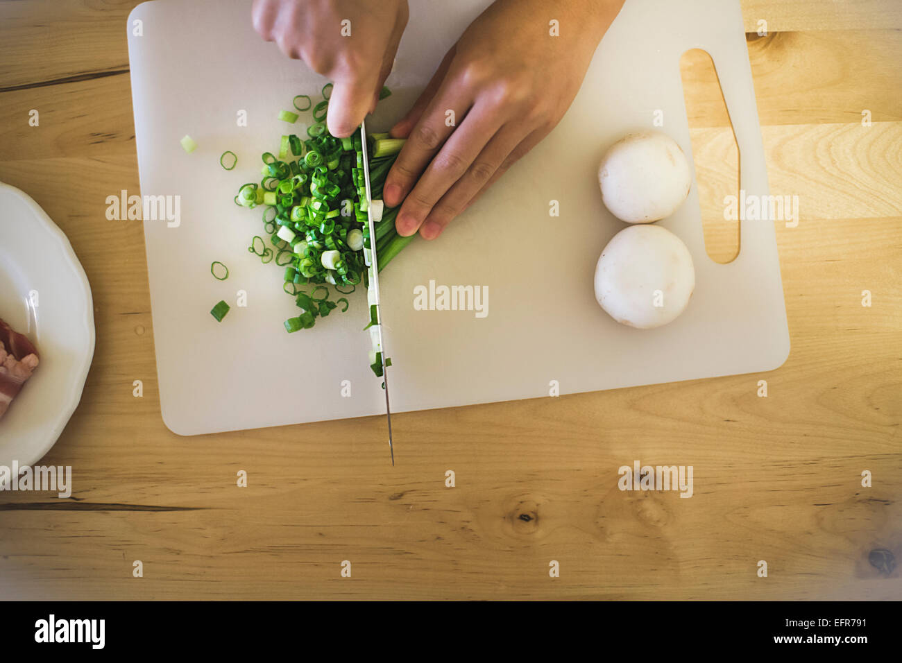 Woman cutting onions hi-res stock photography and images - Alamy