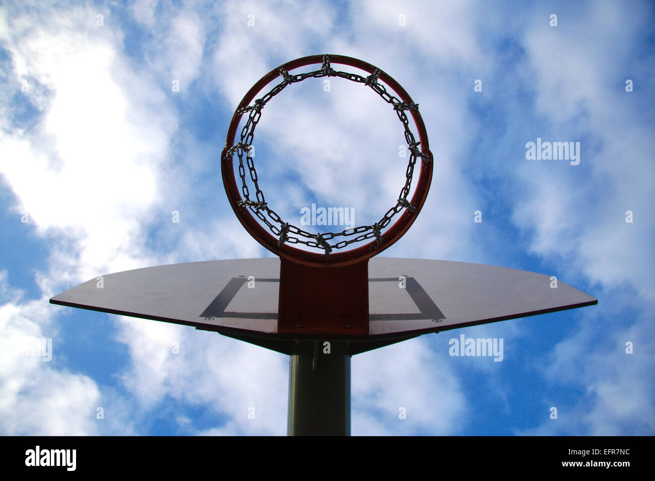 Basketball board and hoop seen from below in an urban background Stock ...
