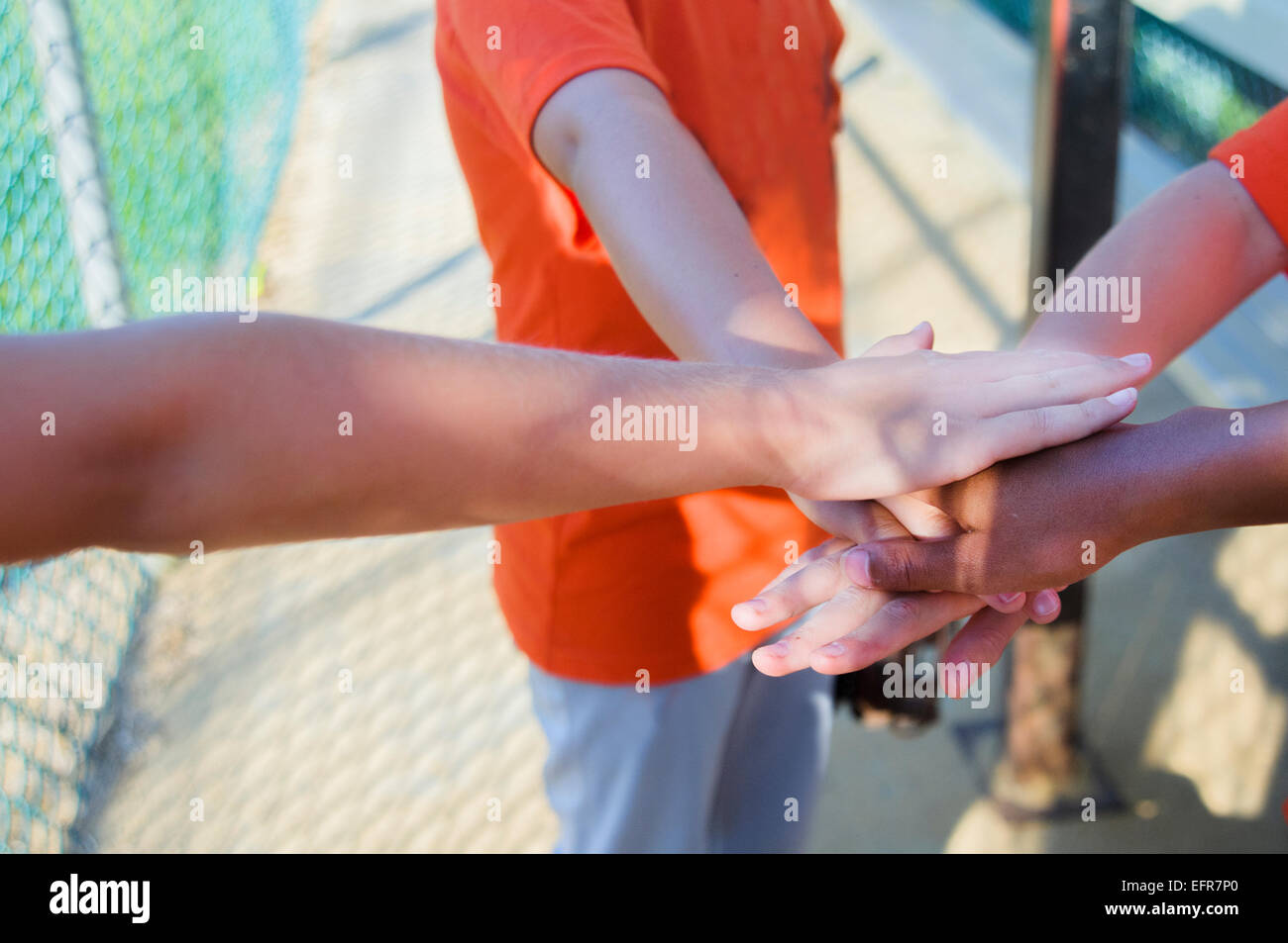Team huddle hands children hi-res stock photography and images - Alamy